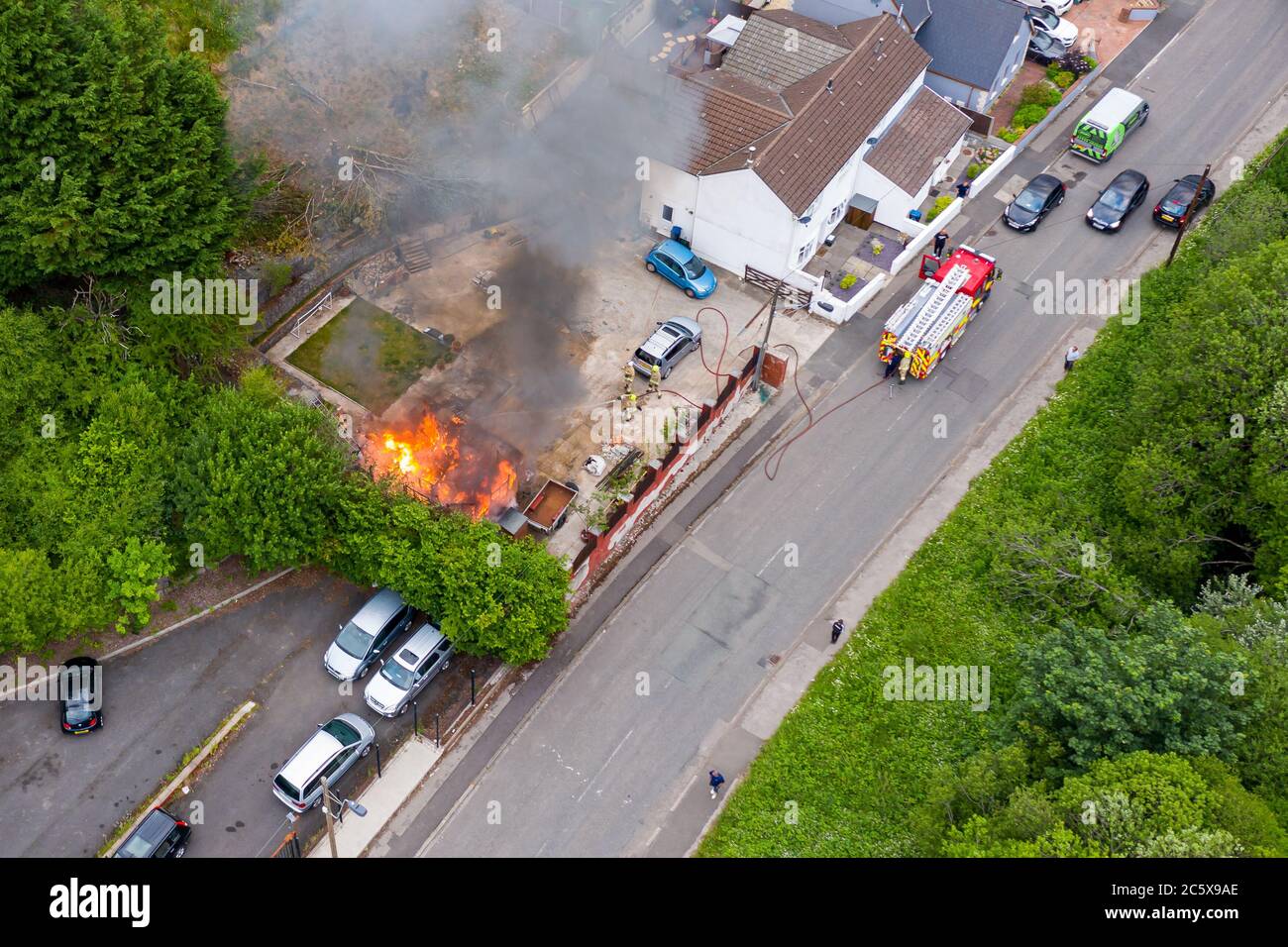 Aerial view of firefighters tackling a small blaze in a domestic ...