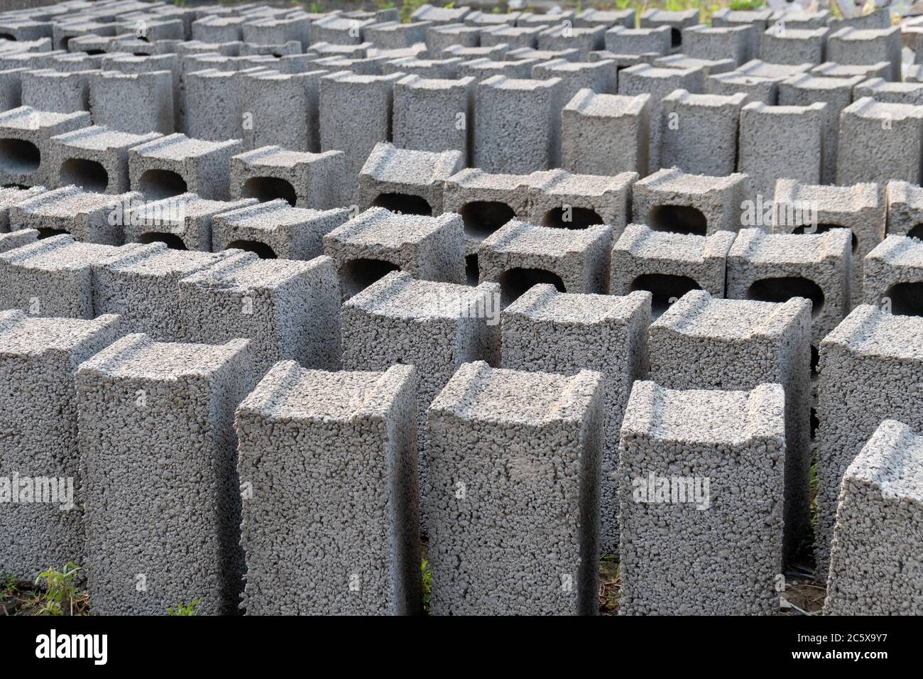 stacks of gray concrete blocks on the ground Stock Photo - Alamy