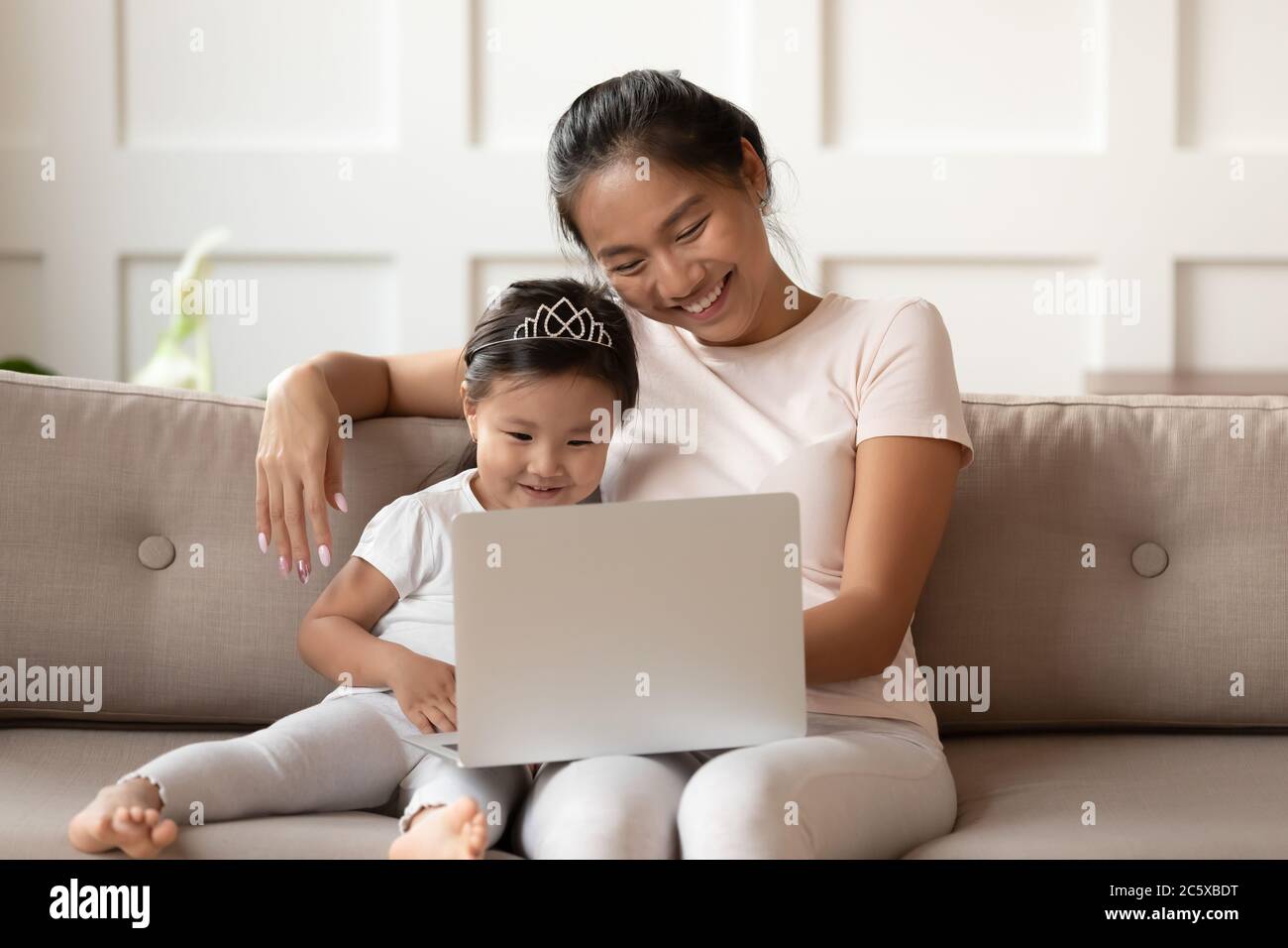 Little cute asian baby using computer with mommy Stock Photo - Alamy