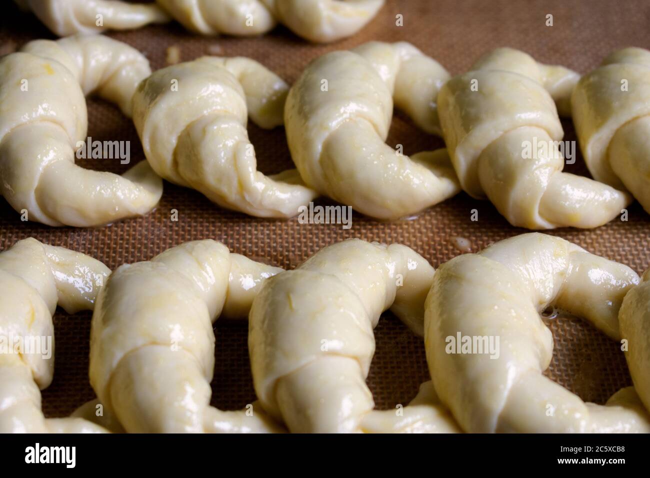 Ready to bake, raw Argentine croissants, medialunas de Manteca over ...