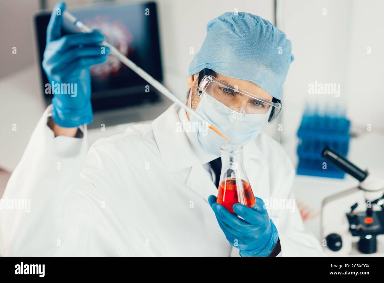 close up. the scientist carefully looking at the test tube Stock Photo ...