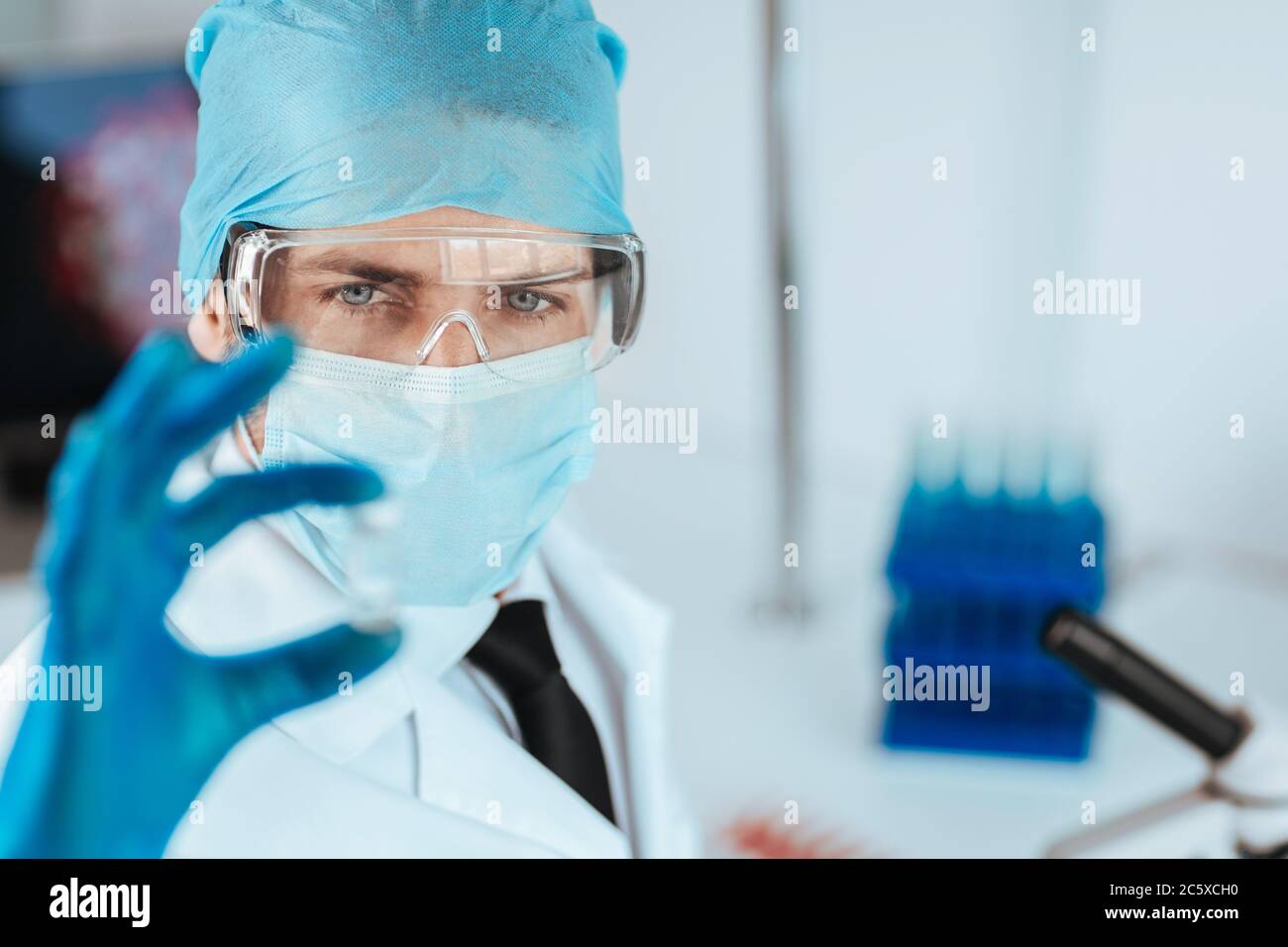close up. scientist looking at a capsule with a new vaccine Stock Photo ...
