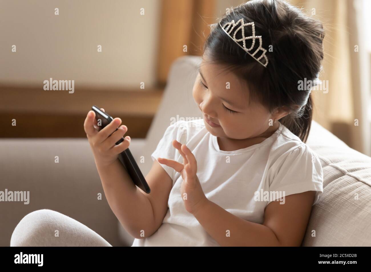 Interested young asian baby learning using smartphone Stock Photo - Alamy