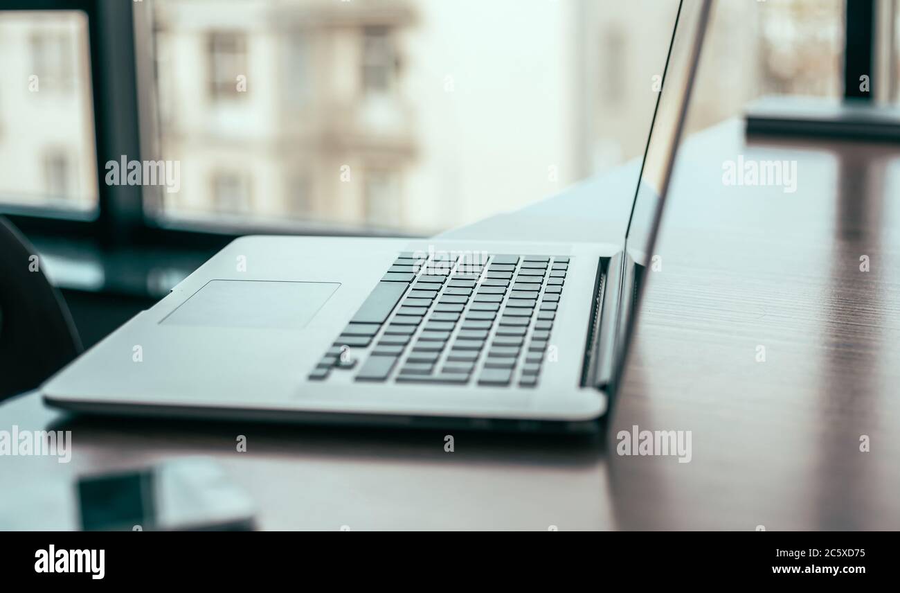 side view. open laptop on the office Desk Stock Photo - Alamy