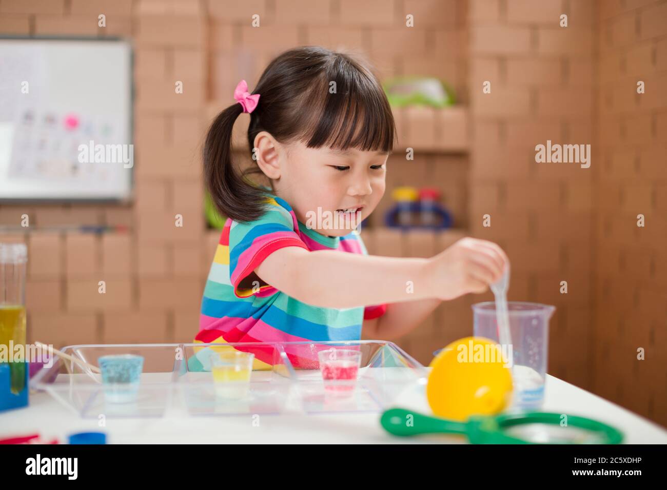 toddler girl play science experiments for homeschooling Stock Photo - Alamy