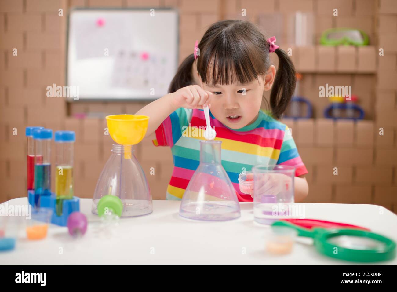 toddler girl play science experiments for homeschooling Stock Photo - Alamy