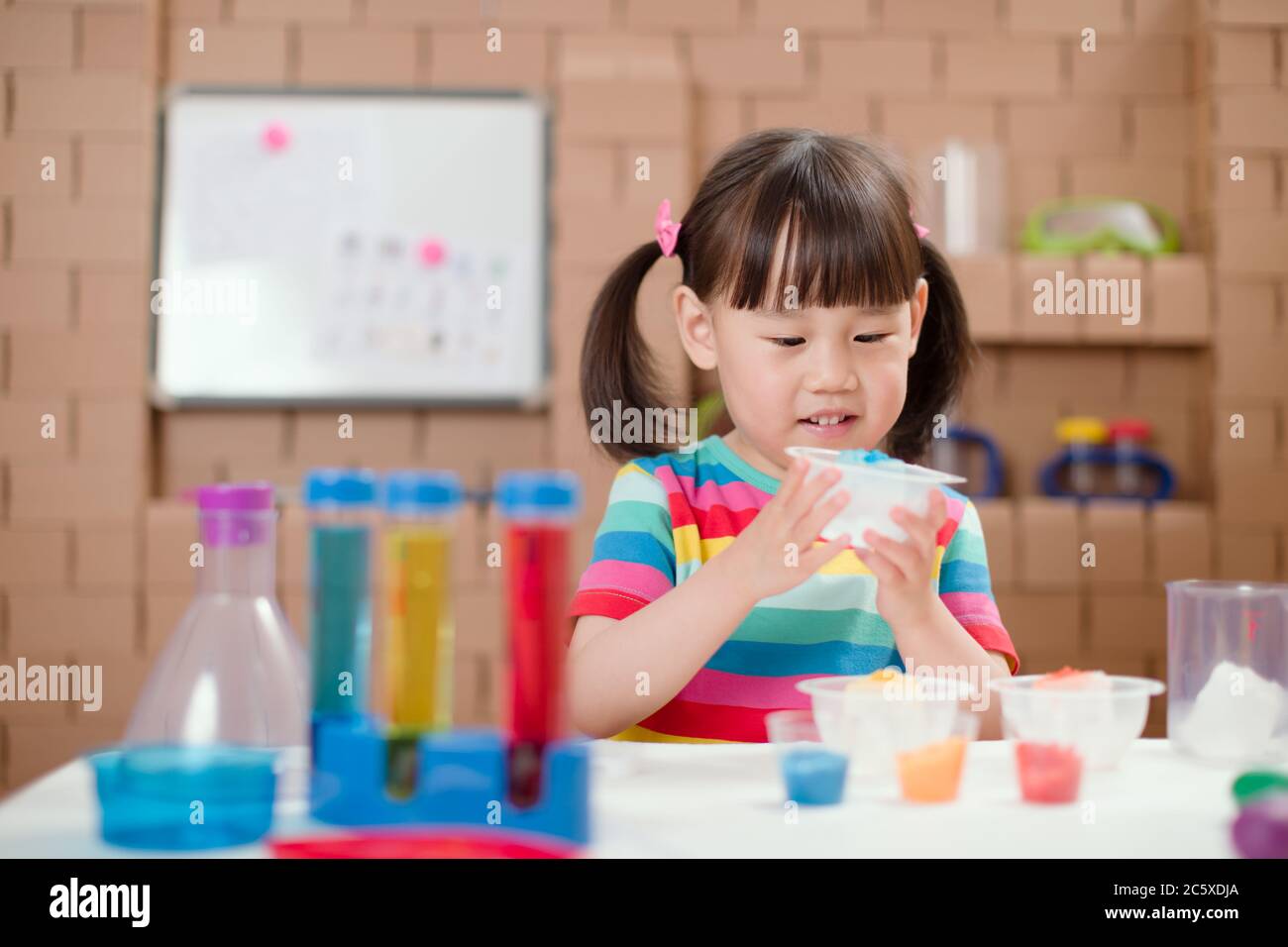 toddler girl play science experiments for homeschooling Stock Photo - Alamy