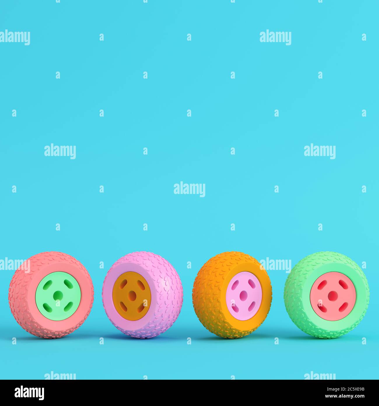 Four colorful car wheels on bright blue background in pastel colors ...