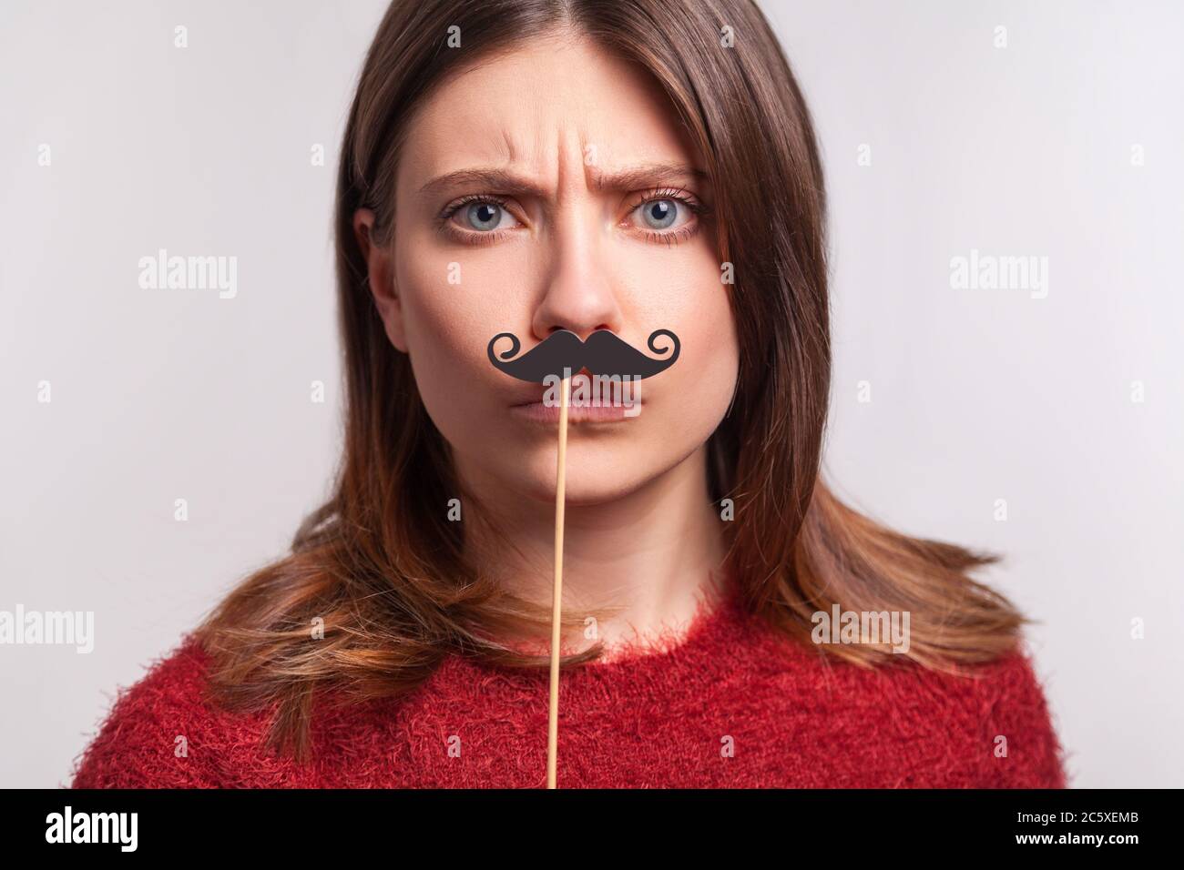 Girl holding fake moustache hi-res stock photography and images - Alamy