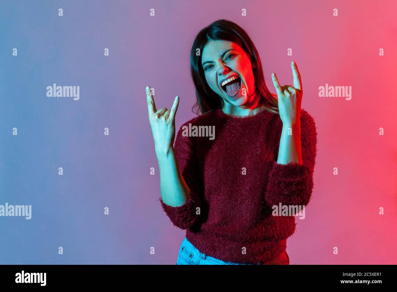 Yeah, that's crazy! Neon light portrait of delighted happy woman ...