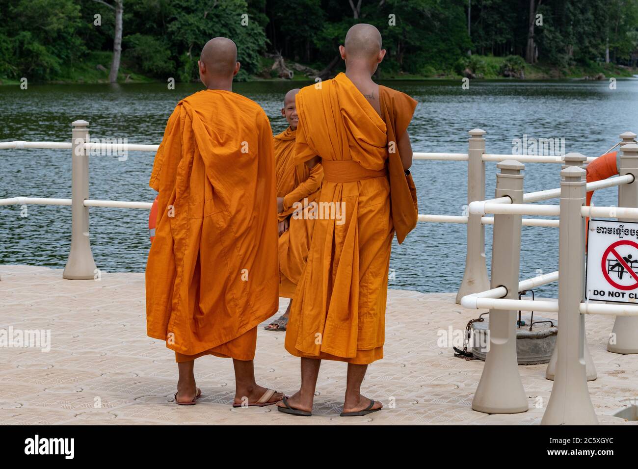 Buddhist monks on the floating bridge just before the first entrance to ...