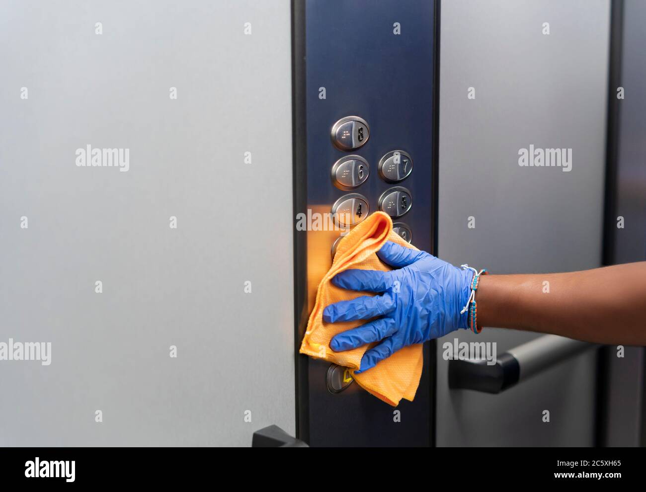 Cleaning professional thoroughly disinfecting elevator push buttons ...