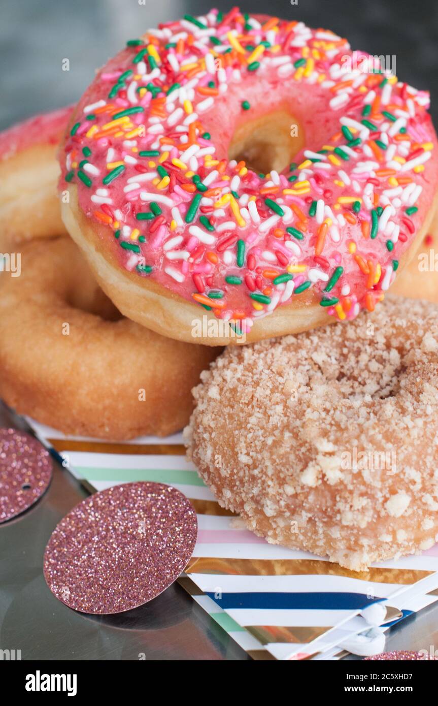 Pink Sprinkle and crumb doughnut Stock Photo - Alamy