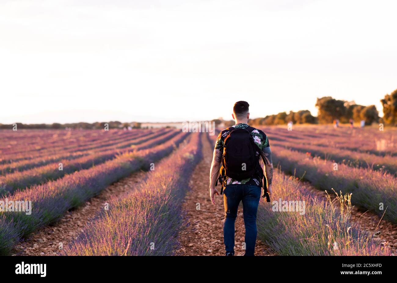 a man with tattoos travels with his backpack Stock Photo - Alamy