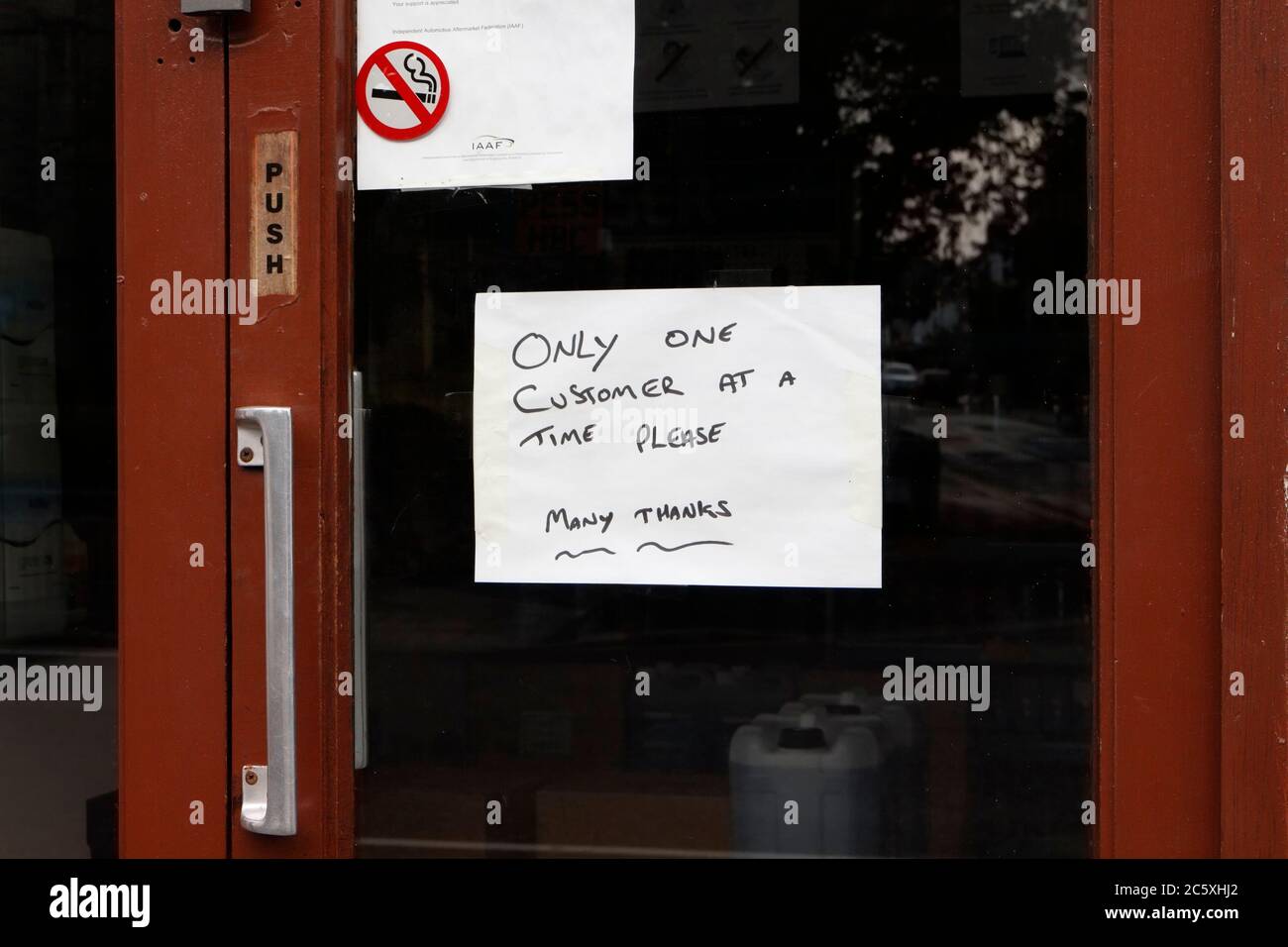 Only one customer at a time, sign on shop door, social distancing ...