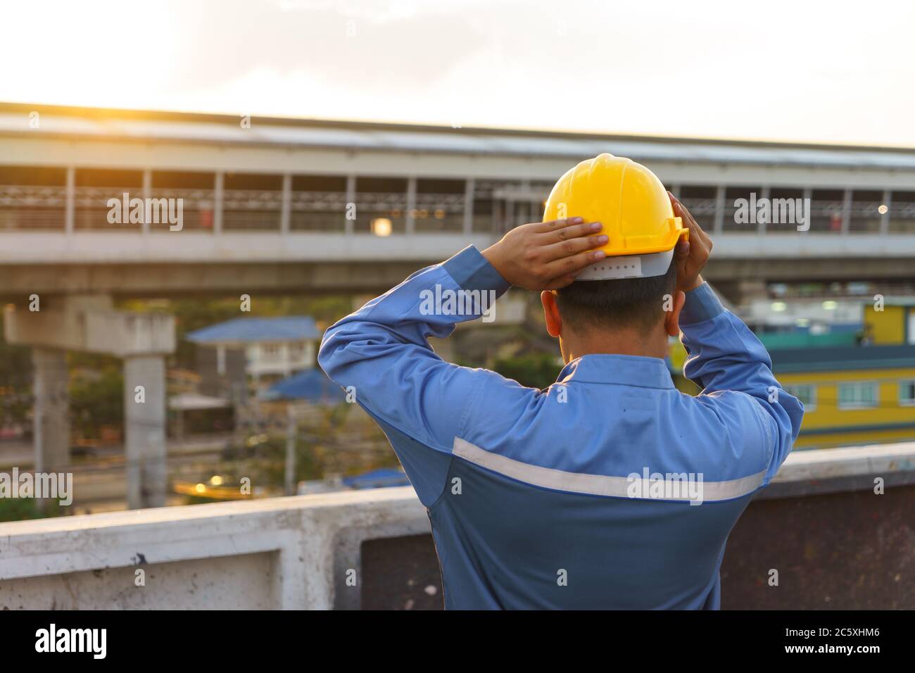 worker is wearing his safety helmet in the morning and ready to work ...