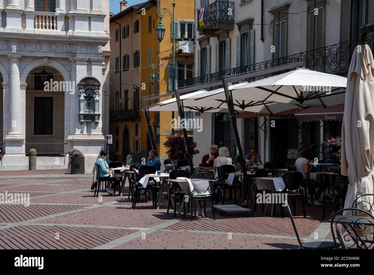 People having lunch at a traditional "Trattoria" on the Piazza Vecchia ...