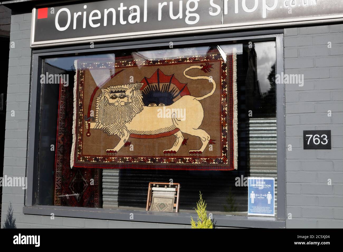 Oriental Rug on display in shop window Stock Photo - Alamy