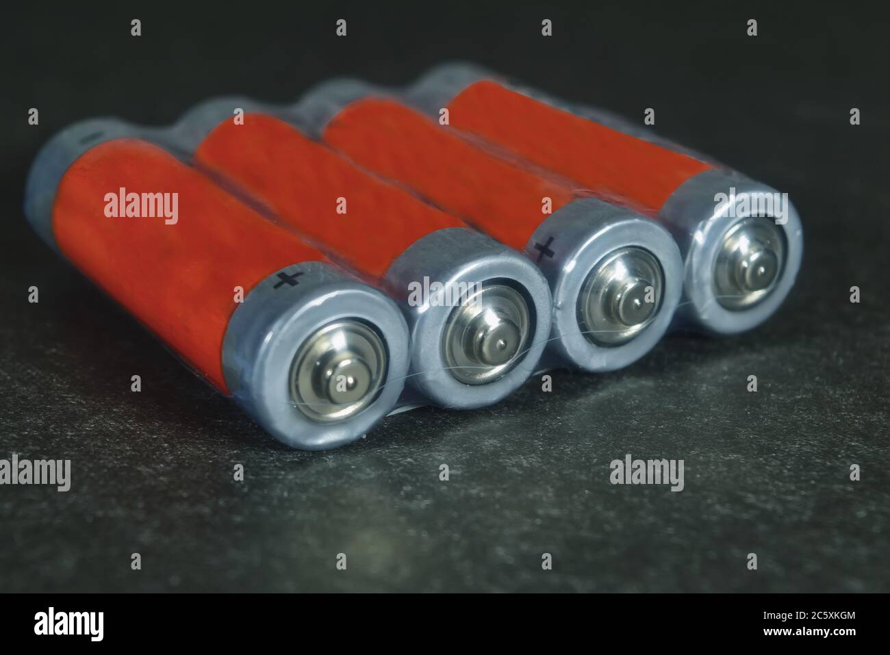 Packing electric alkaline batteries on a dark background Stock Photo ...