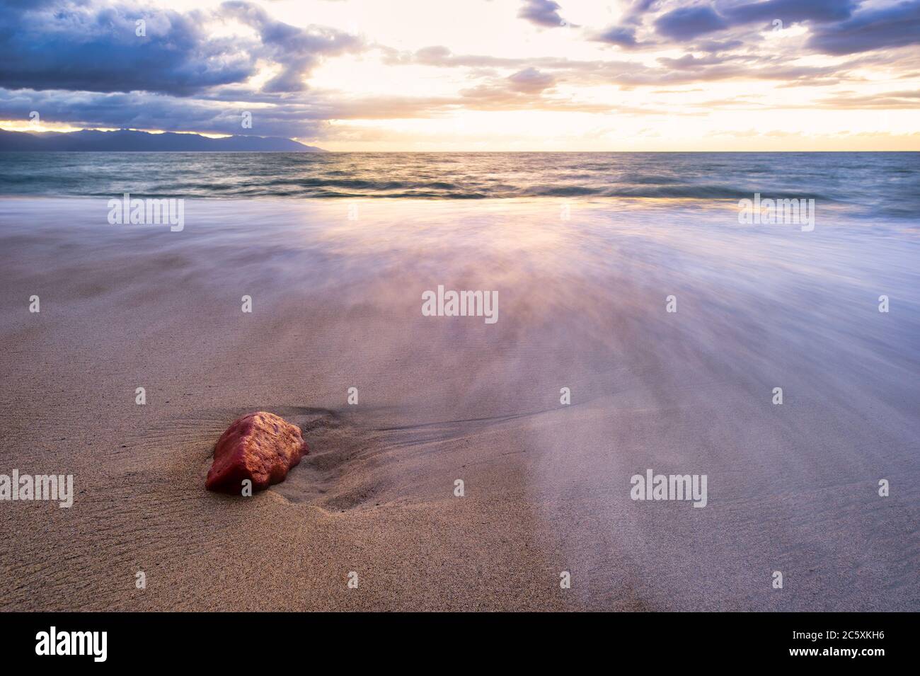 Ocean Water Rushes to the Shore Breaking on a Single Rock on the ...