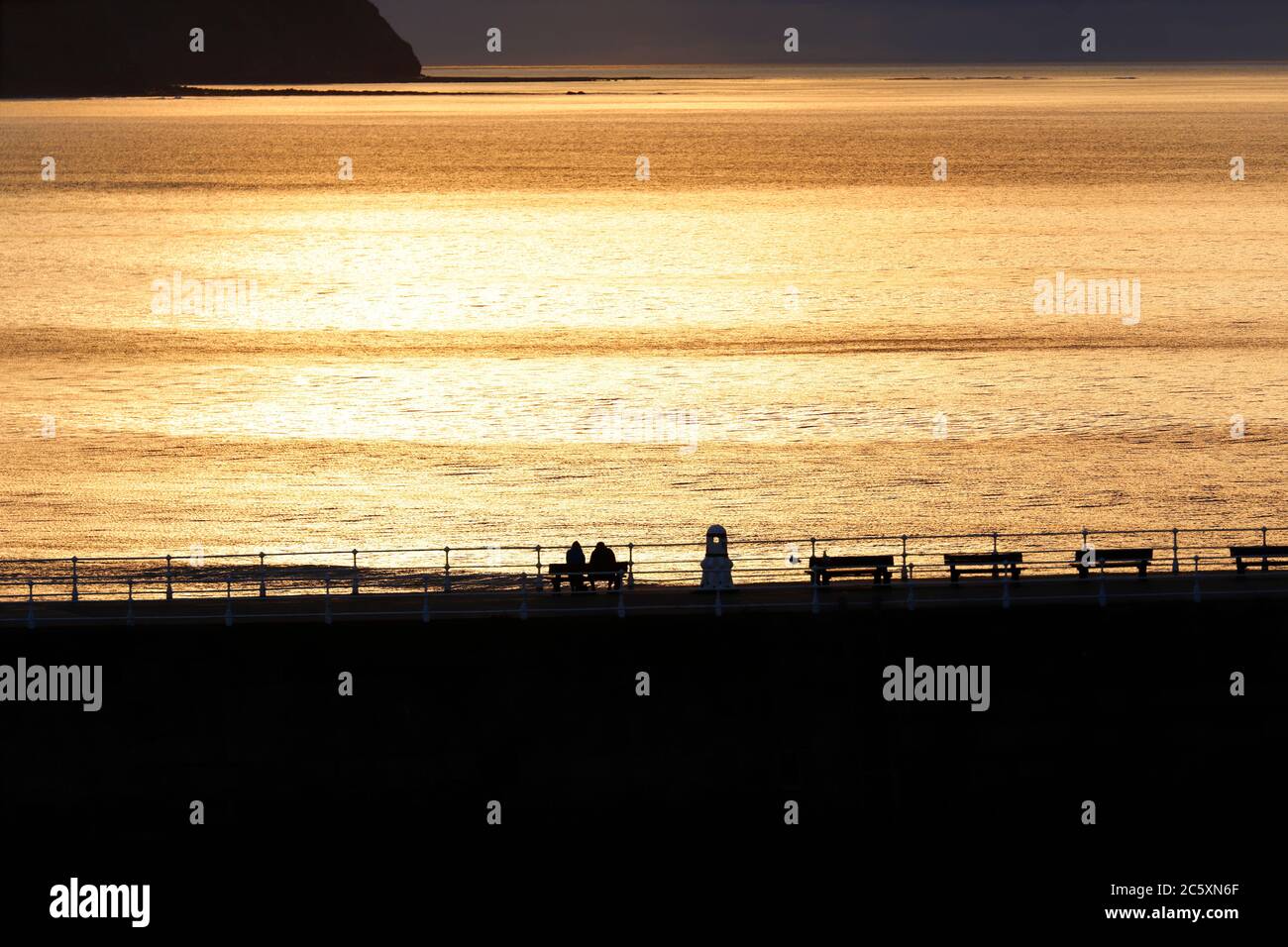 Sunset over Whitby Pier in North Yorkshire Stock Photo - Alamy