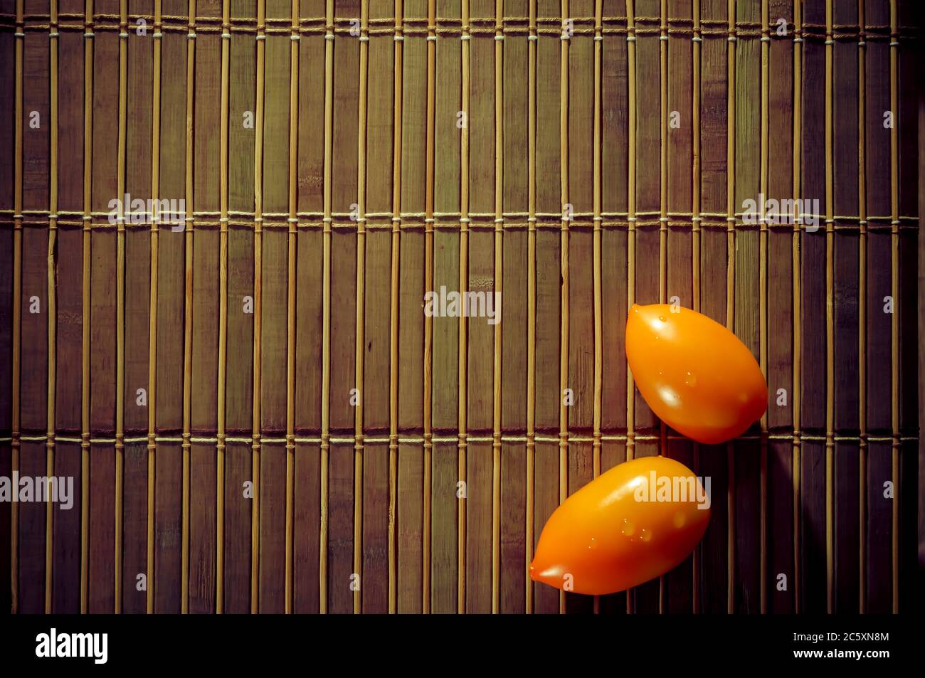 Autumn still life - yellow and chocolate tomatoes on bamboo Mat Stock ...