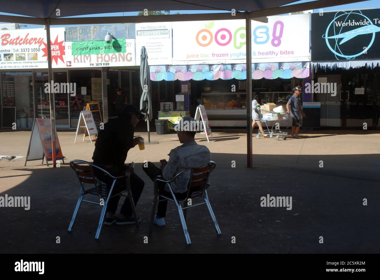 Men sat on chairs, Inala Plaza, Inala, Brisbane, Queensland, Australia ...
