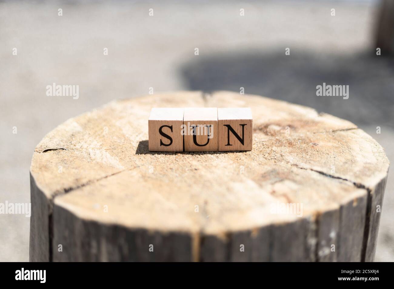 Sun from wooden cubes. The cubes are on the tree stump Stock Photo - Alamy