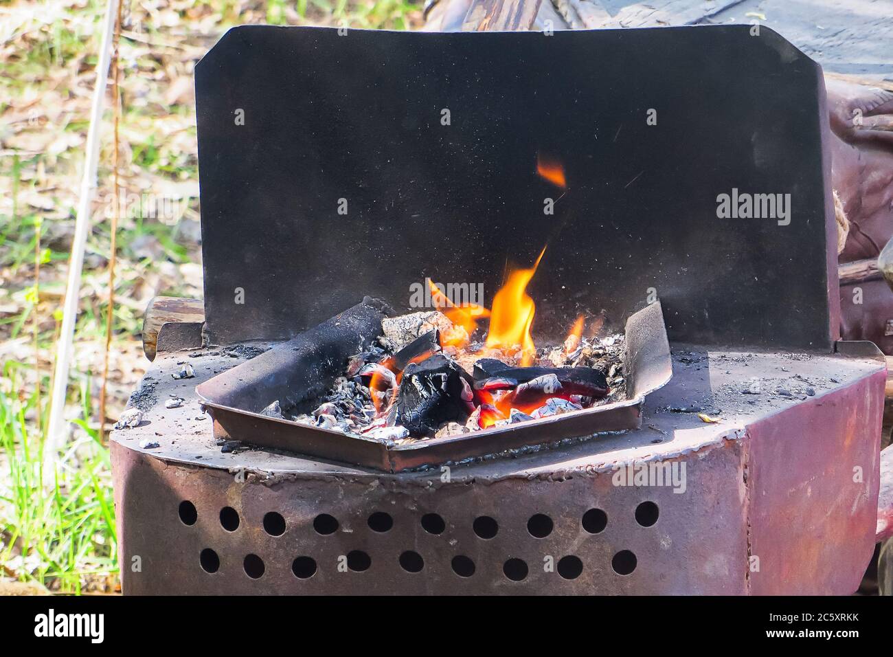 Camping outdoors - tents, equipment and cooking. Cooking at a camping ...