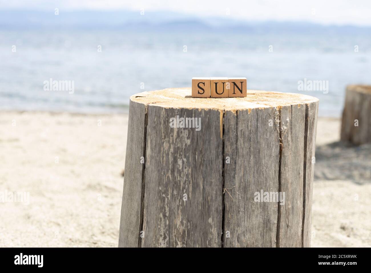 Sun from wooden cubes. The cubes are on the tree stump Stock Photo - Alamy