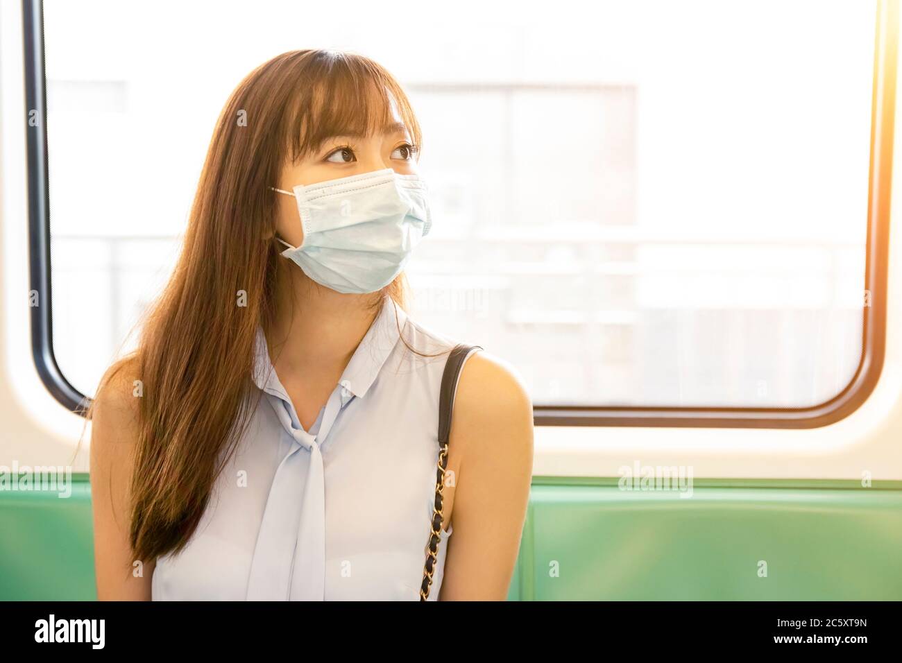 Woman sitting in train wearing hi-res stock photography and images - Alamy