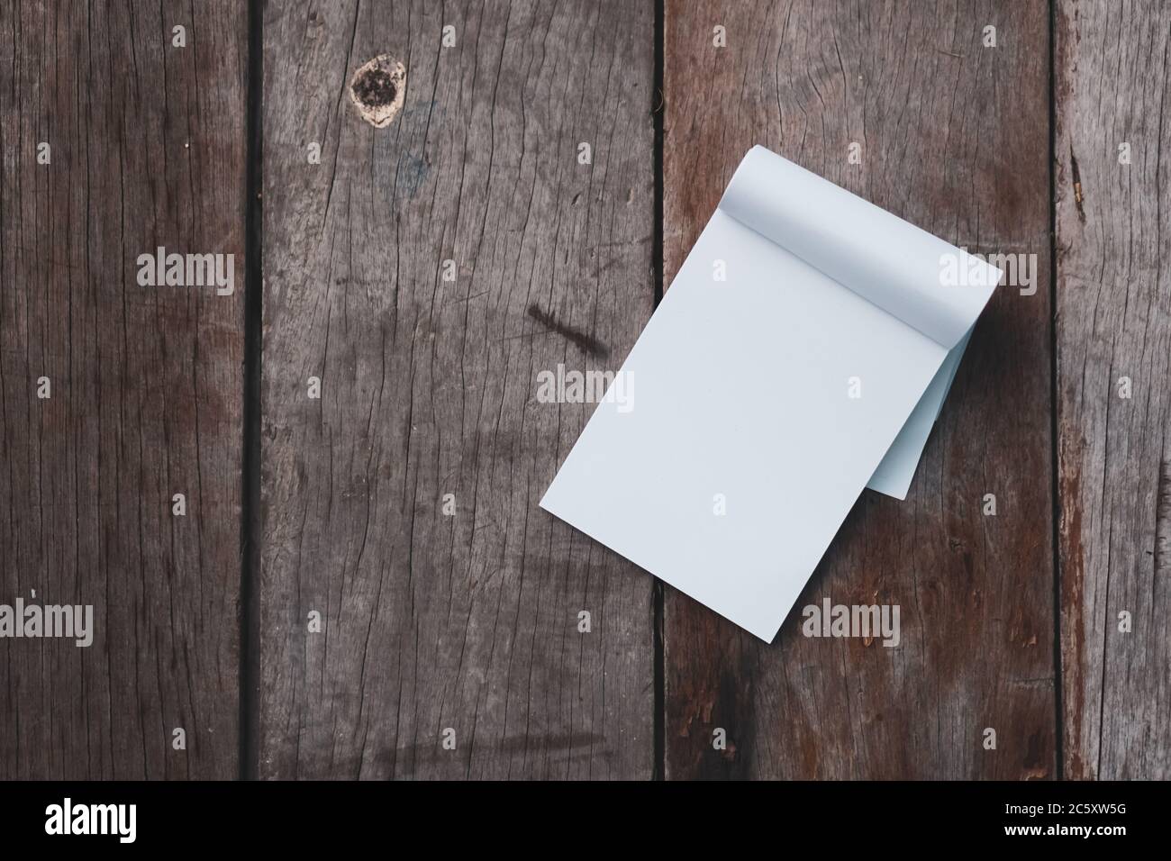 Small white notebook on old grunge wood texture background Stock Photo ...