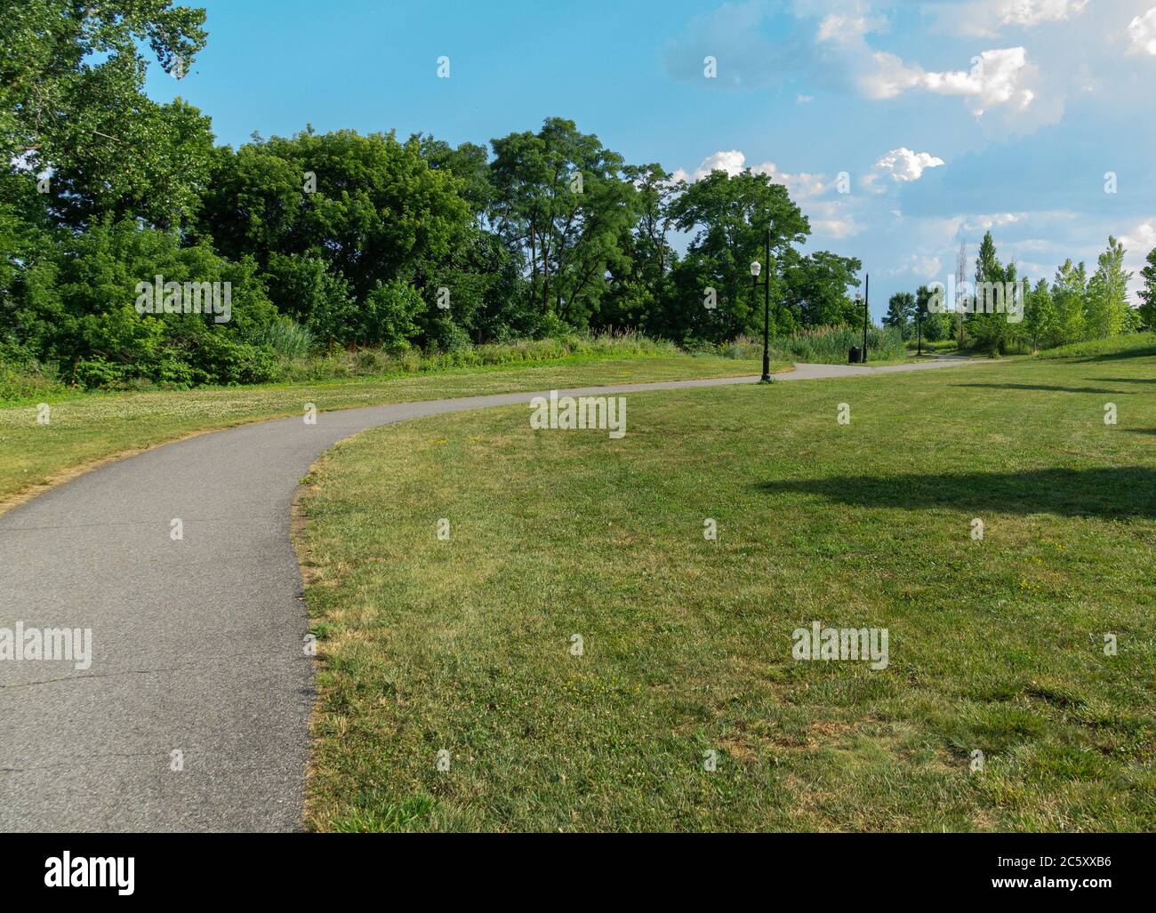 New Overpeck County Park walking path leading down to river Stock Photo ...