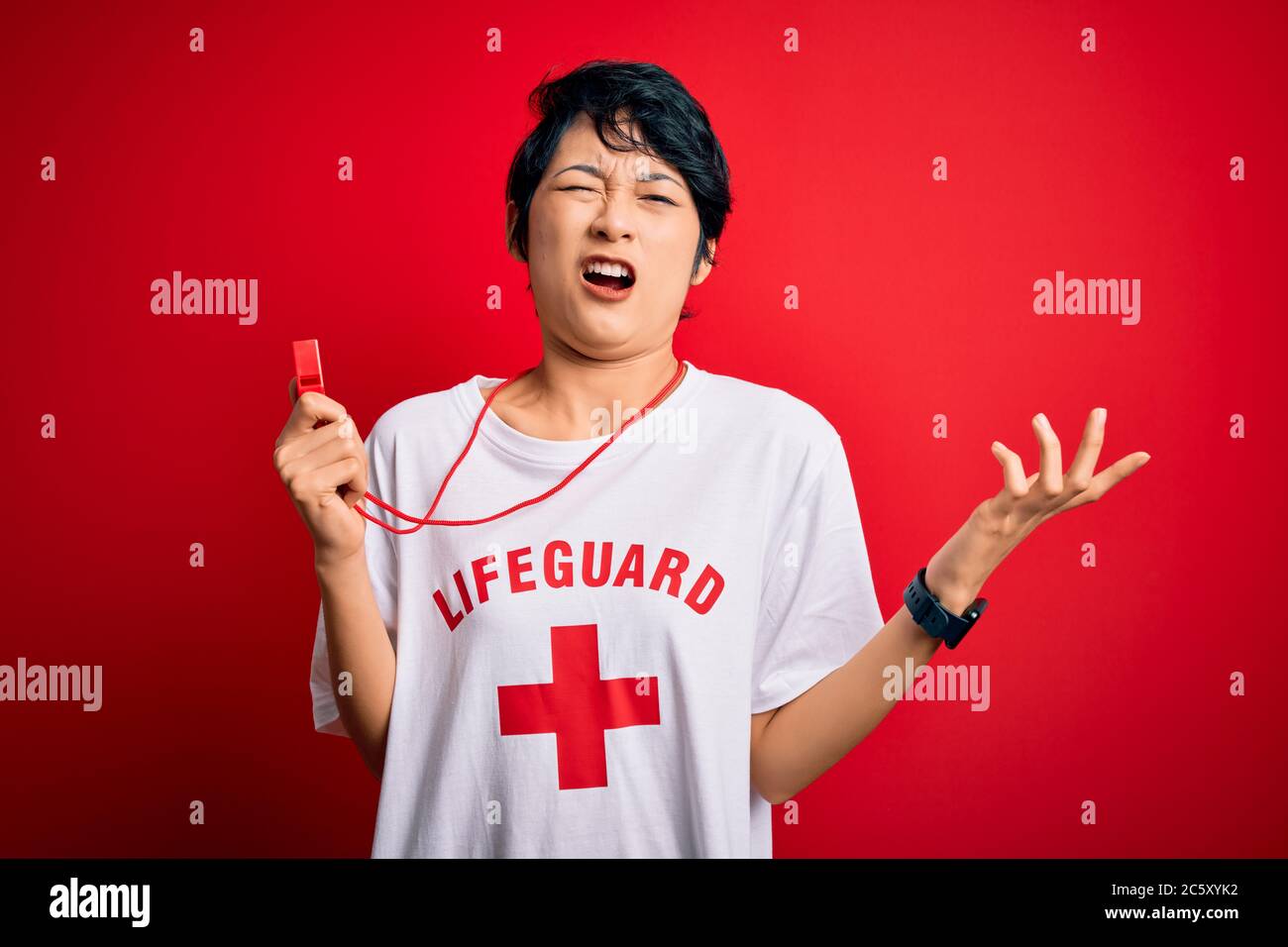 Young beautiful asian lifeguard girl wearing t-shirt with red cross ...