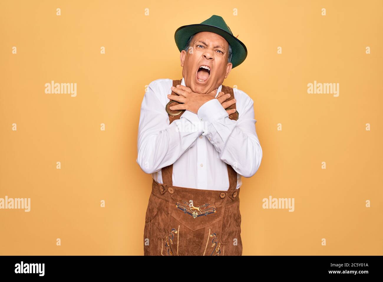 Senior grey-haired man wearing german traditional octoberfest suit over ...