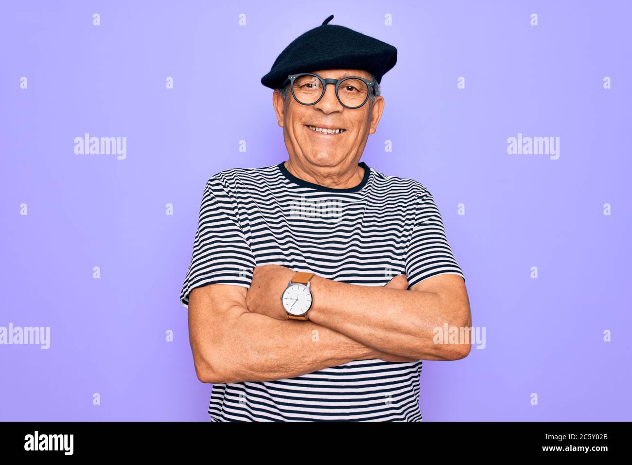 Senior handsome hoary man wearing french beret and glasses standing ...