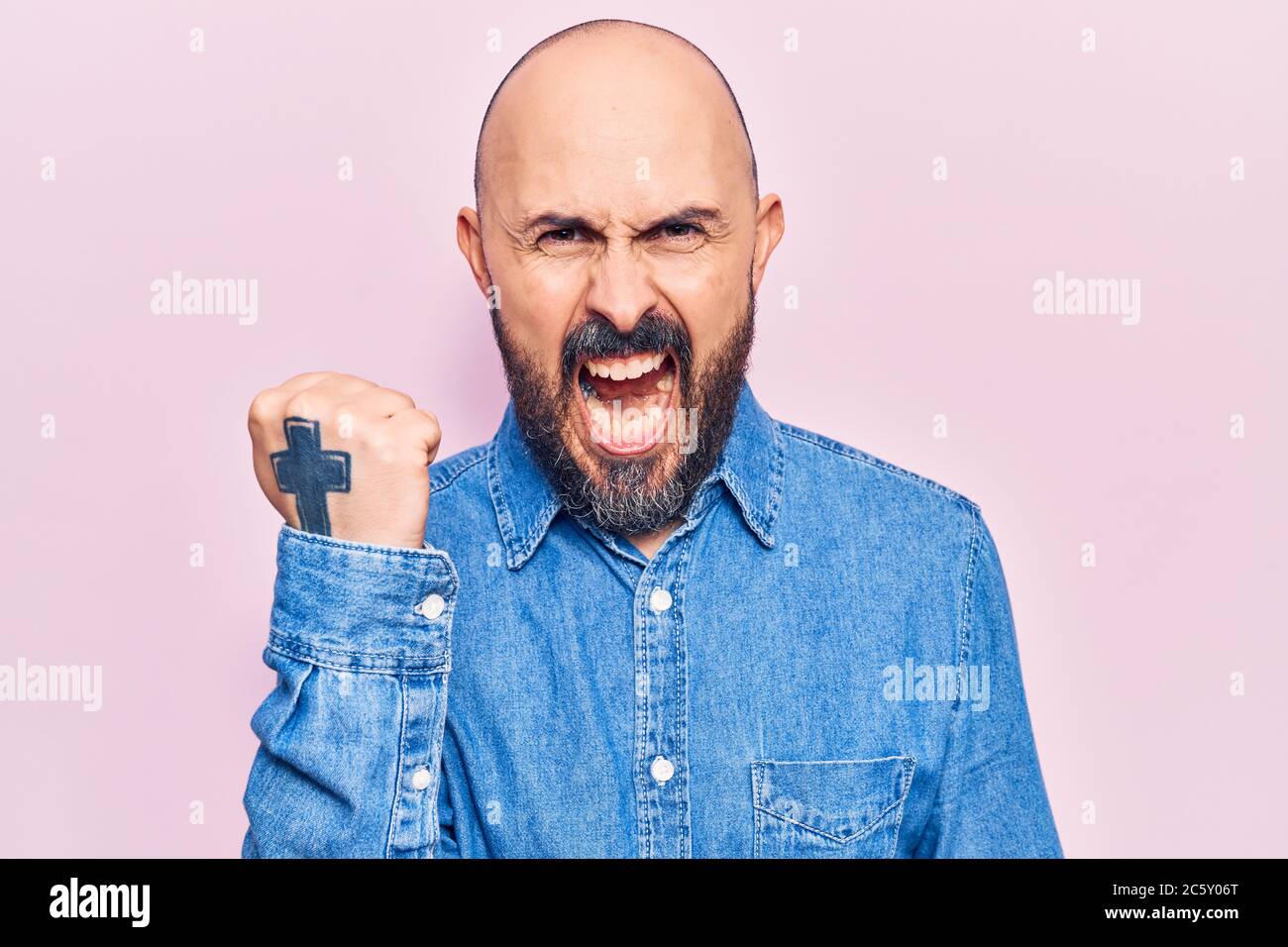 Young handsome man wearing casual clothes angry and mad raising fist ...