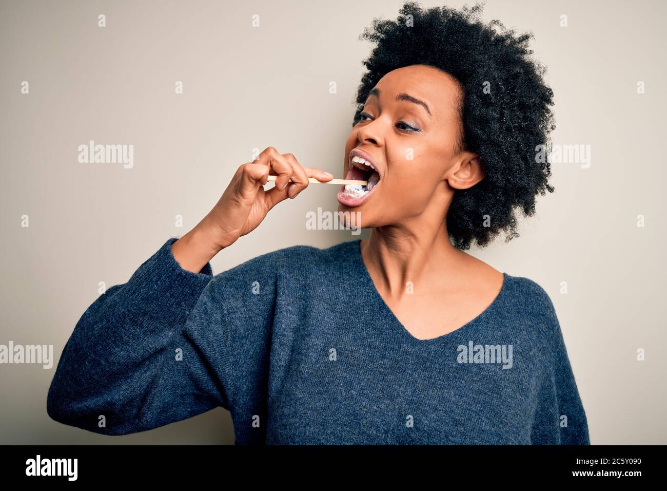 African american woman brushing her teeth using tooth brush and oral ...