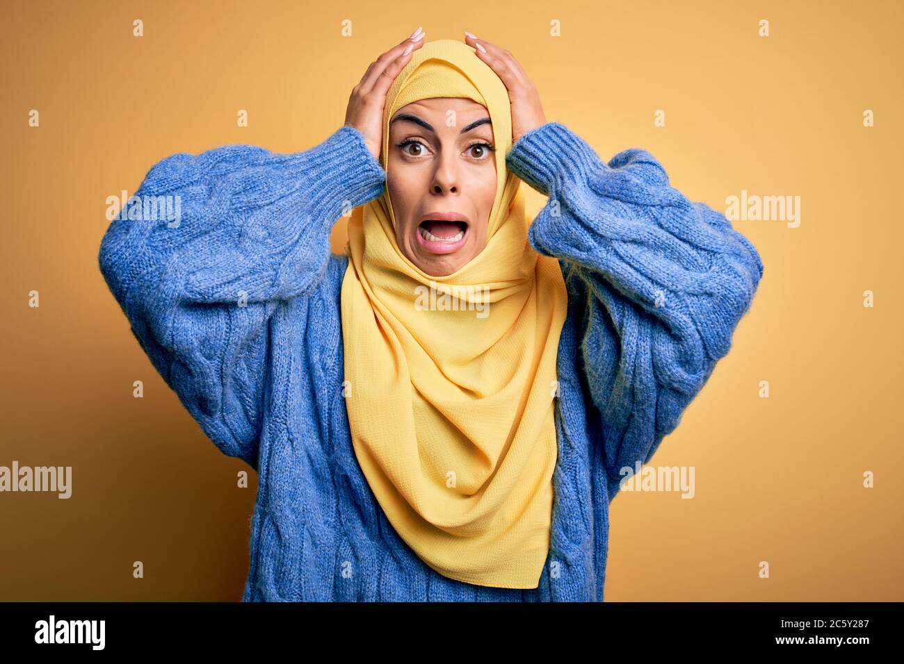 Young beautiful brunette muslim woman wearing arab hijab over isolated ...