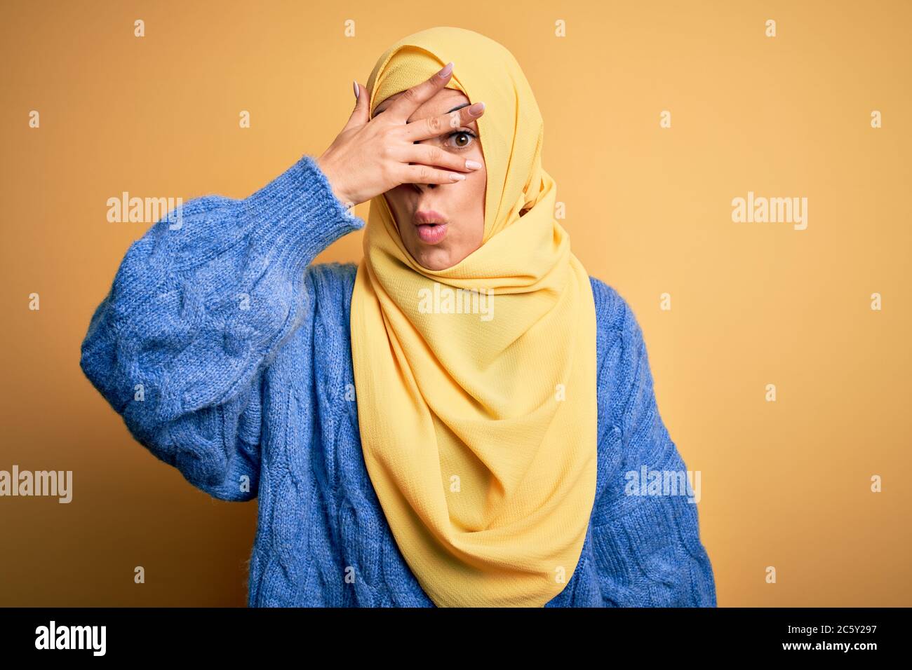 Young beautiful brunette muslim woman wearing arab hijab over isolated ...