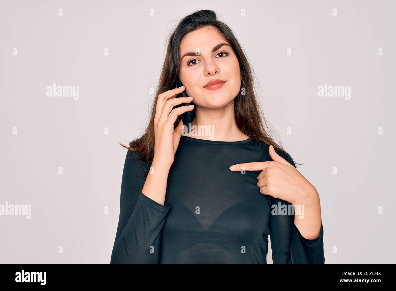 Young beautiful woman having a conversation talking on smartphone ove ...