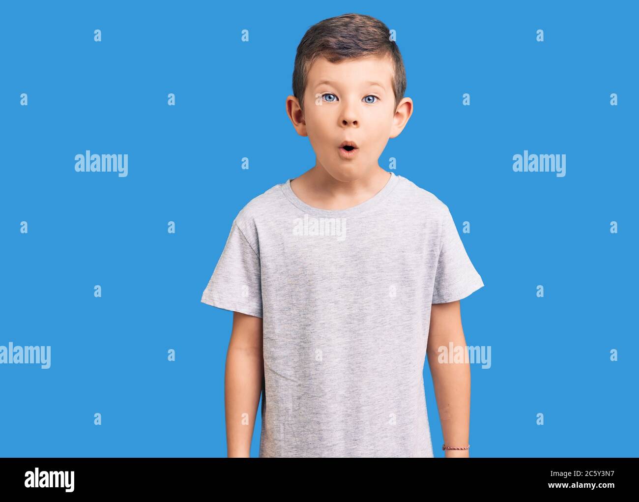 Cute blond kid wearing casual clothes scared and amazed with open mouth ...