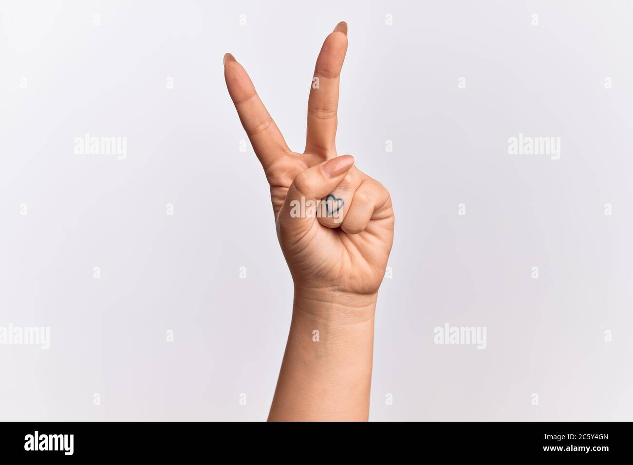 Hand of caucasian young woman counting number 2 showing two fingers ...
