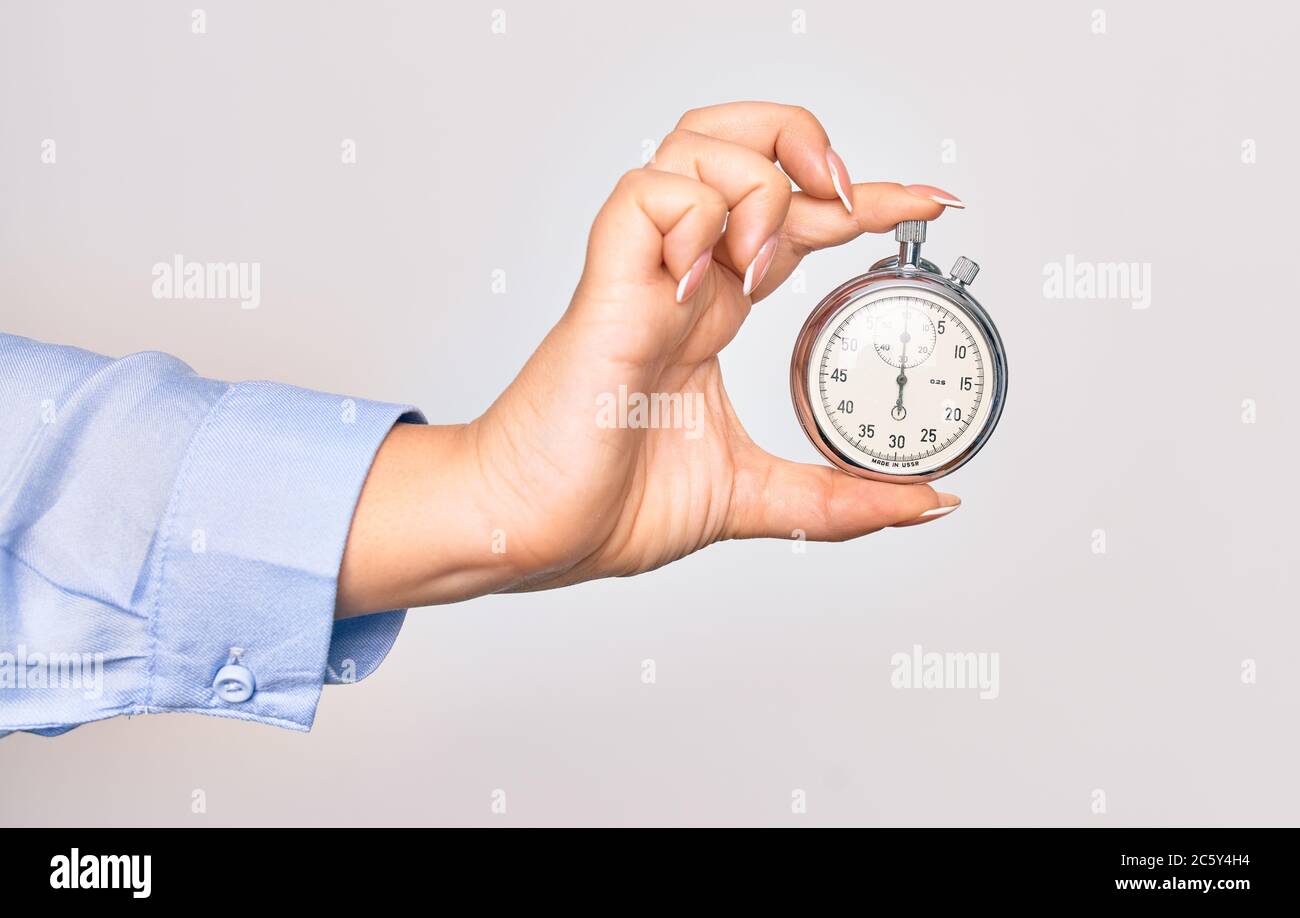 Hand of caucasian young woman counting time using stopwatch over ...
