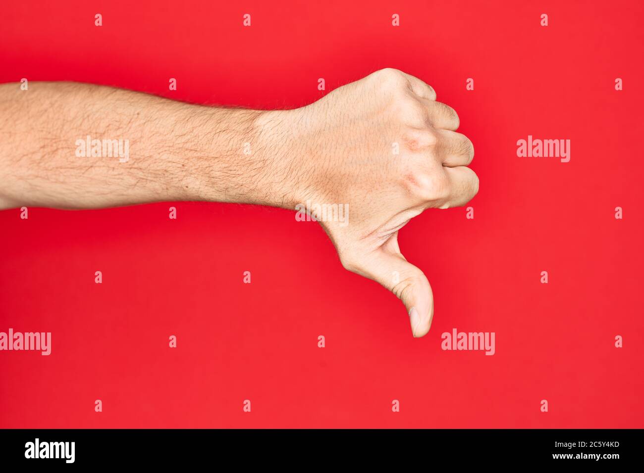 Hand of caucasian young man showing fingers over isolated red ...