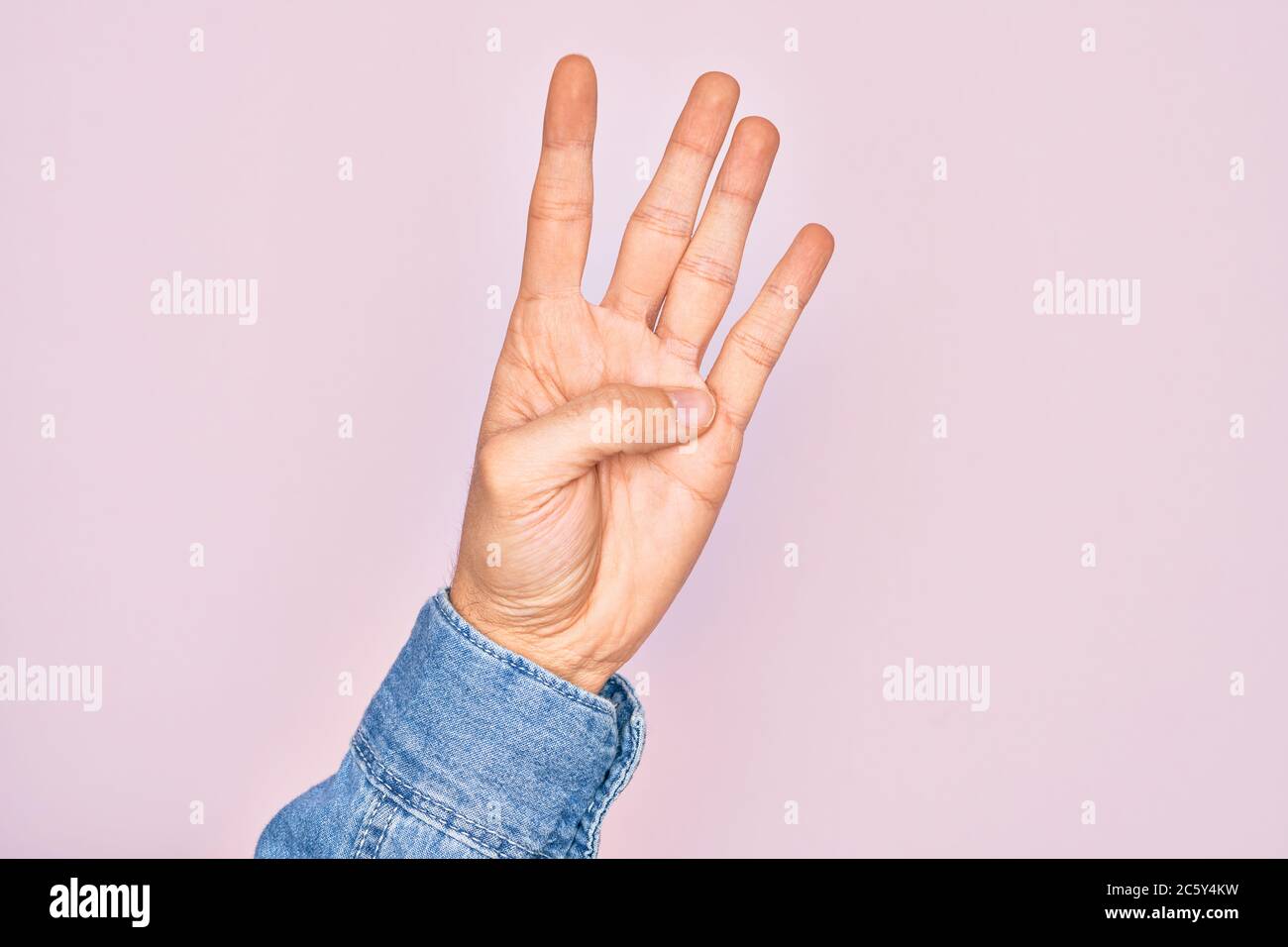 Hand of caucasian young man showing fingers over isolated pink ...