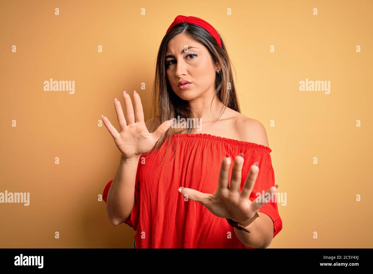 Young beautiful woman colorful summer style over yellow isolated ...