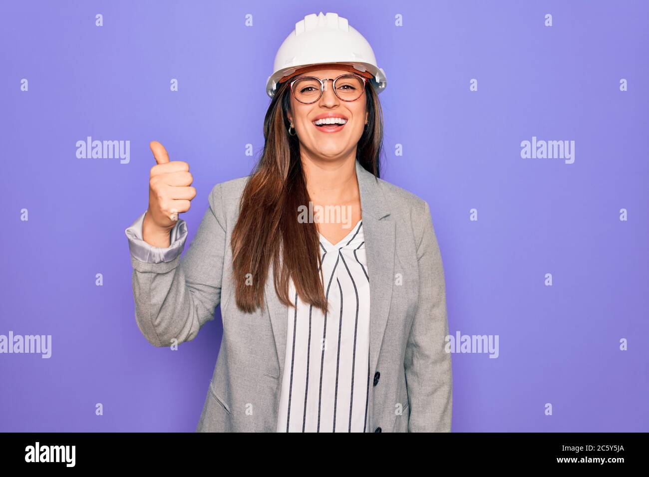 Professional woman engineer wearing industrial safety helmet over ...