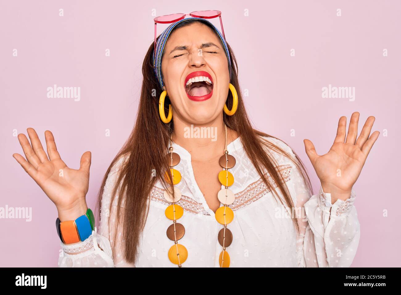 Young hispanic hippie woman wearing fashion boho style and sunglasses ...