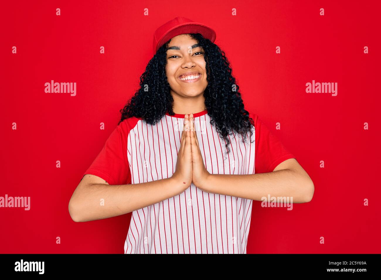 Young african american curly sportswoman wearing baseball cap and ...